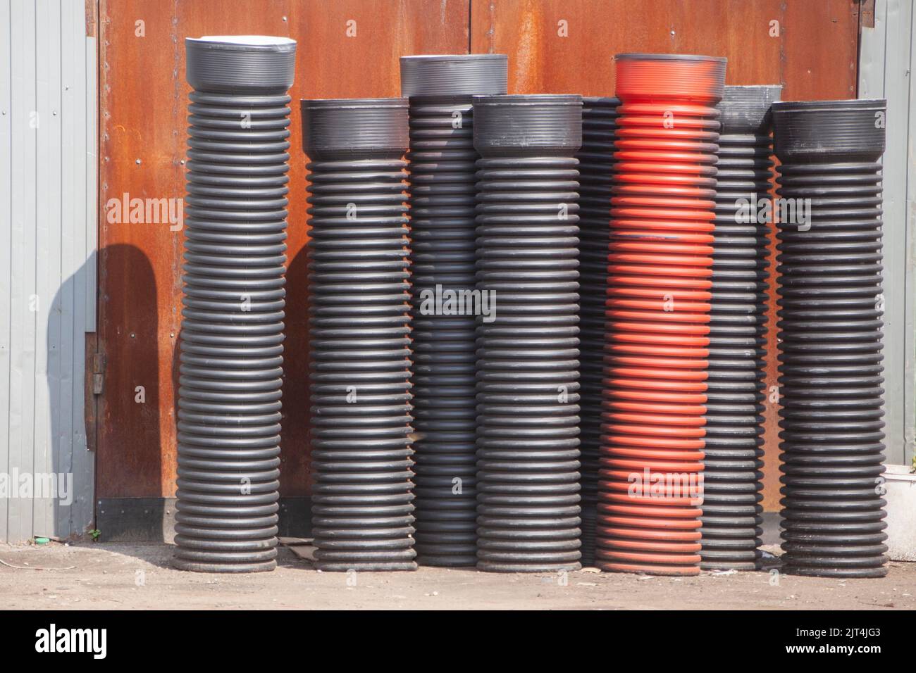 Plastic pipes for sewerage on street. Ribbed pipes in stock. Sewerage ...
