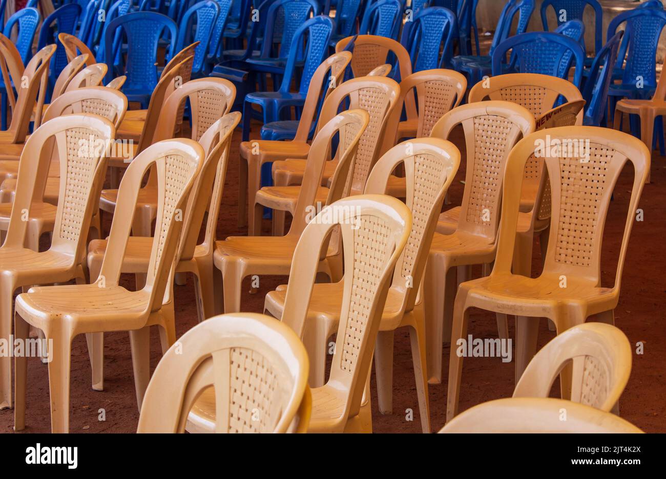 Plastic chairs getting organized for a public event. Chairs in an ...