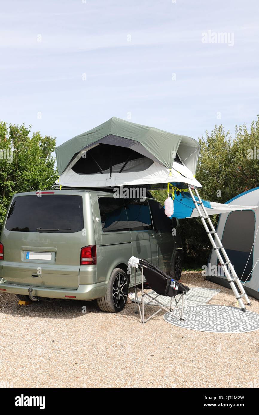 a new gray camper van with a roof tent Stock Photo - Alamy