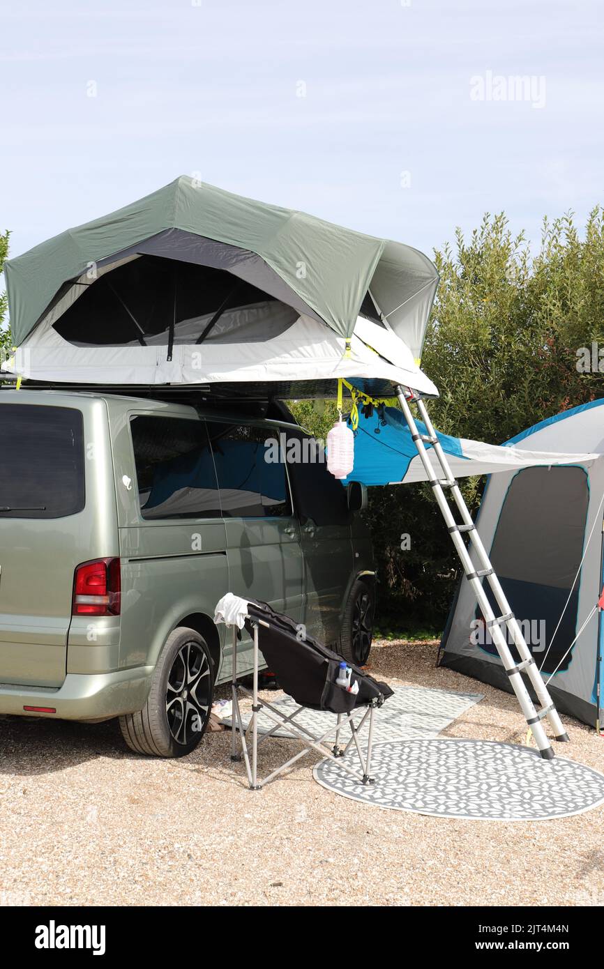 a new gray camper van with a roof tent Stock Photo - Alamy