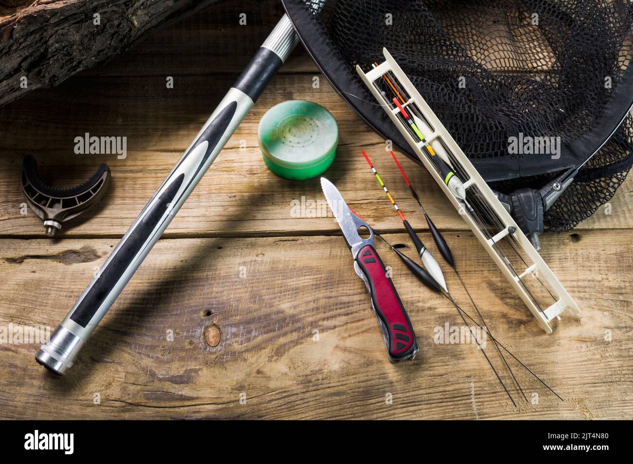 Old fishing tackle and an army knife. Fishing rod and floats. Fisherman ...