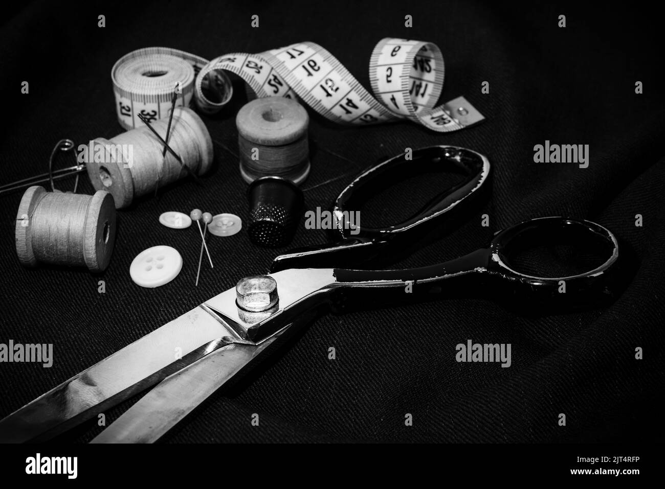 Retro tools for cutting and sewing. Needle with thread, thimble, sewing ...