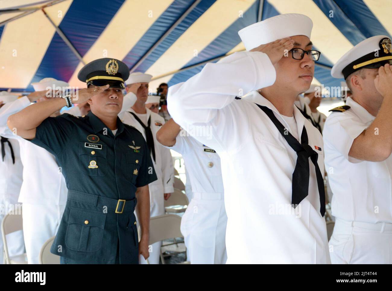 U.S. and Philippine sailors salute during the opening ceremony for ...
