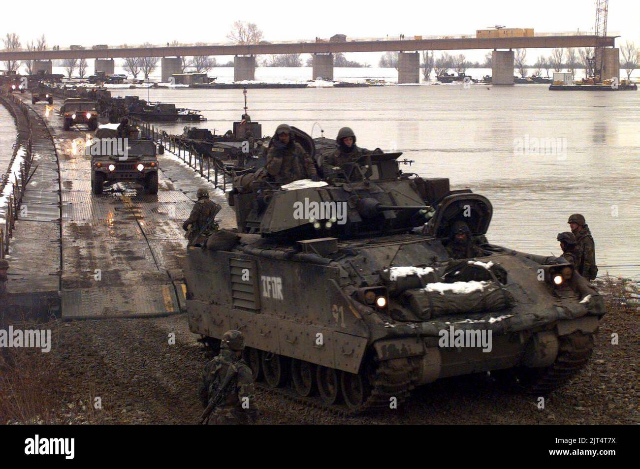 U.S. Army Armored Cavalry troops move across the bridge over the Sava ...