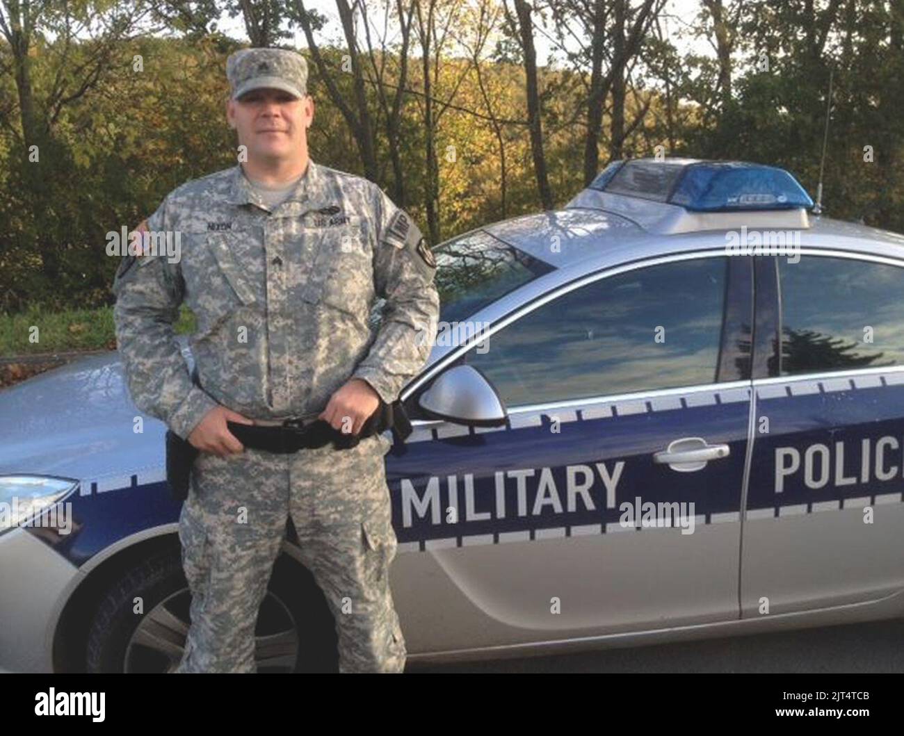 U.S. Army Military Police officer standing in front of his Patrol Car ...