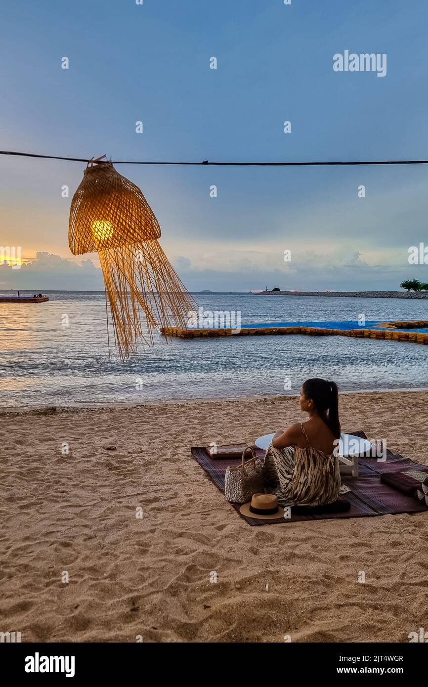 women bbq cooking noodle soup during sunset in Thailand Ban Amphur ...