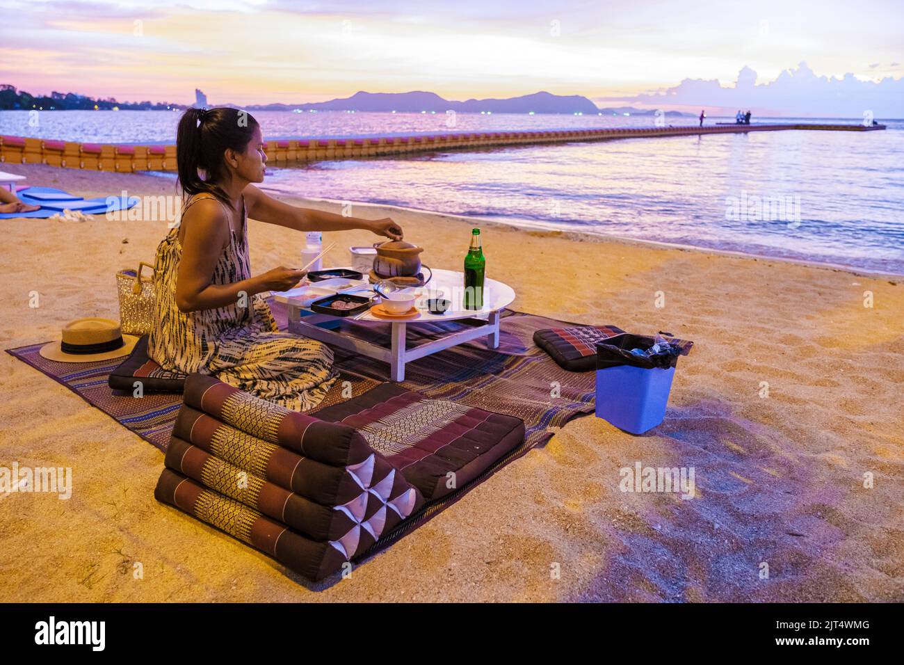 women bbq cooking noodle soup during sunset in Thailand Ban Amphur ...