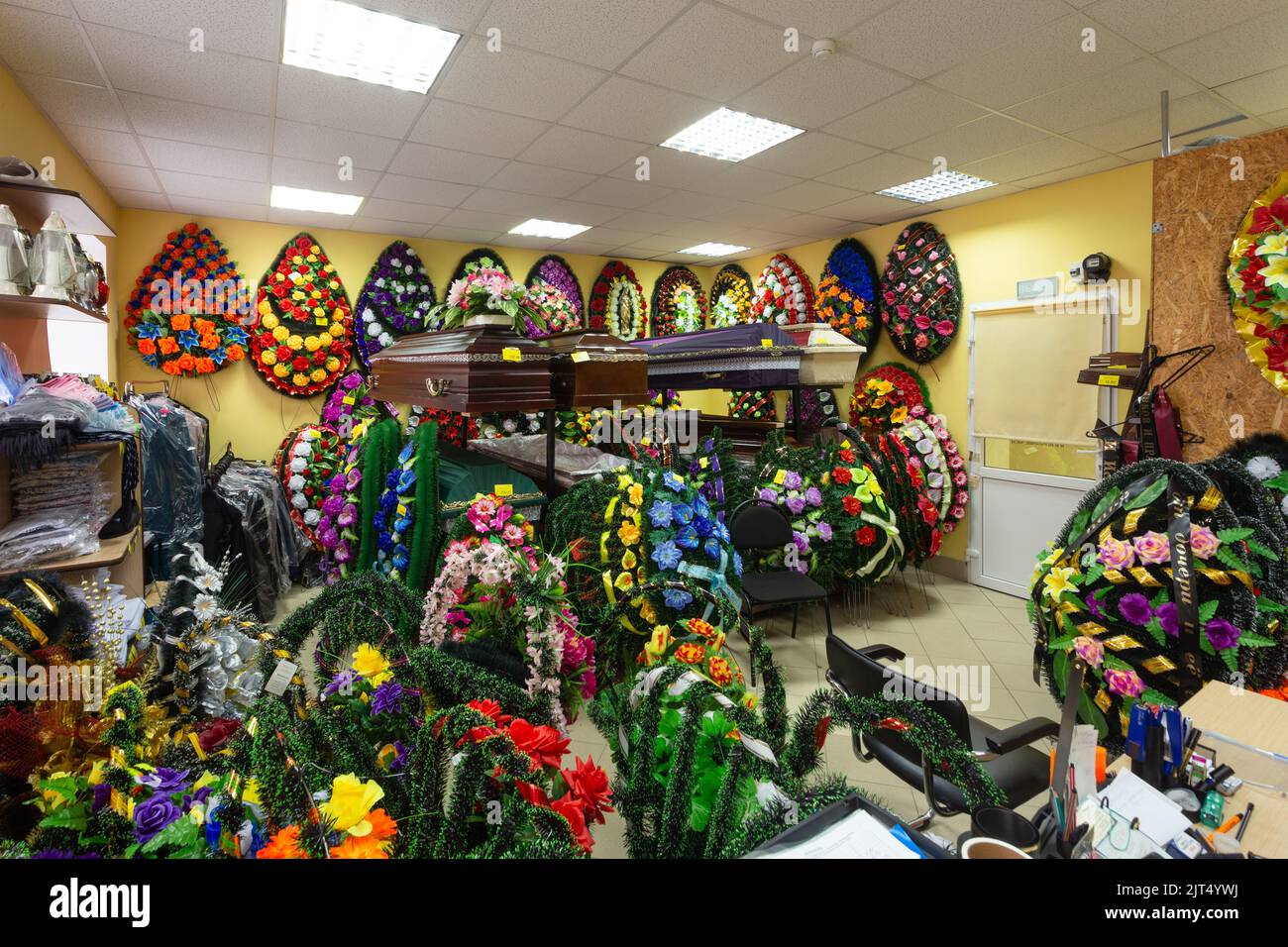 Interior of room with funeral accessories. Shop selling coffins ...
