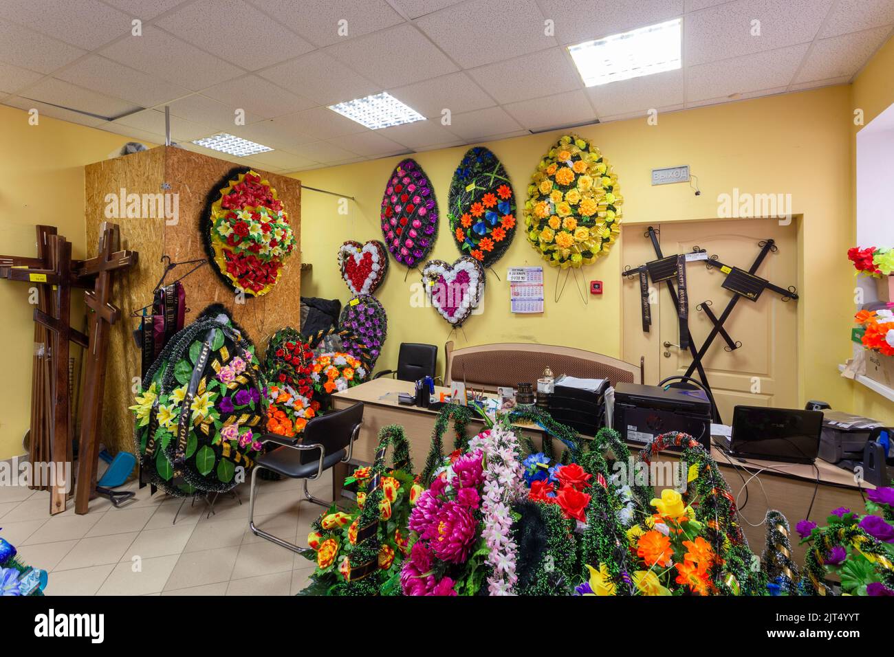 Interior of room with funeral accessories. Shop selling coffins ...