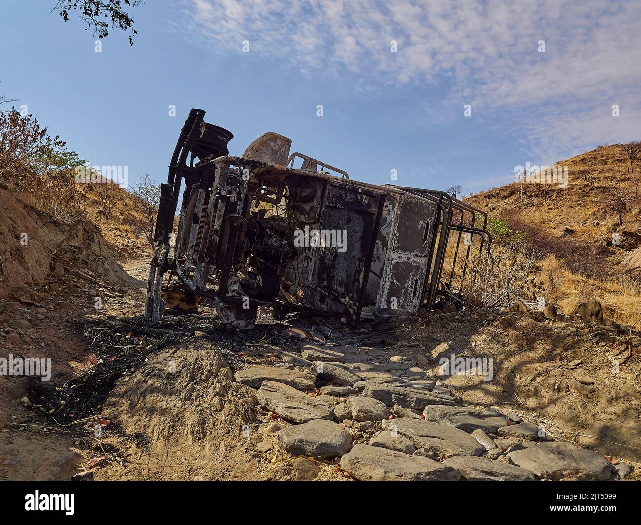 burnt out car wreck lying on its side on steep Jan Joubert mountain ...