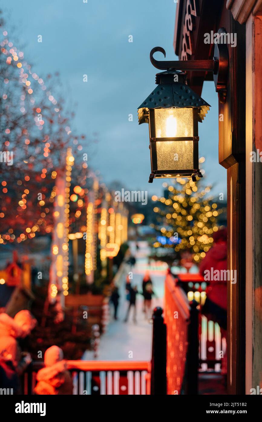 Vertical Christmas market lantern light with burred background with ...