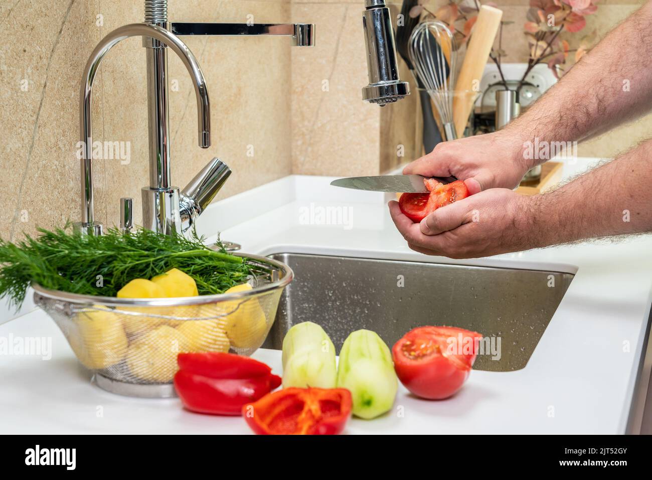 Cleaning and cutting fresh vegetables in the kitchen Stock Photo - Alamy