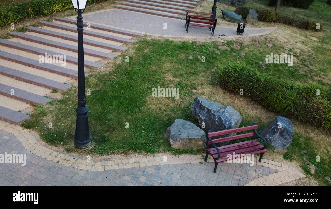Pedestrian paths in the city park. Vintage benches and lanterns. City ...