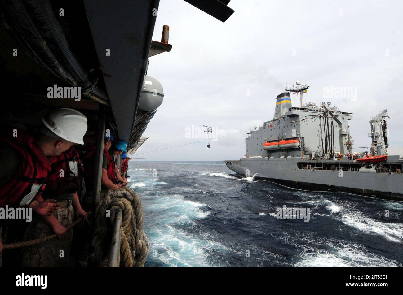 U.S. Marines aboard the dock landing ship USS Comstock (LSD 45) watch ...