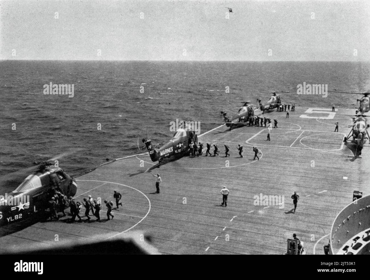 U.S. Marines board Sikorsky HUS-1 of HMR-362 aboard USS Princeton (LPH ...