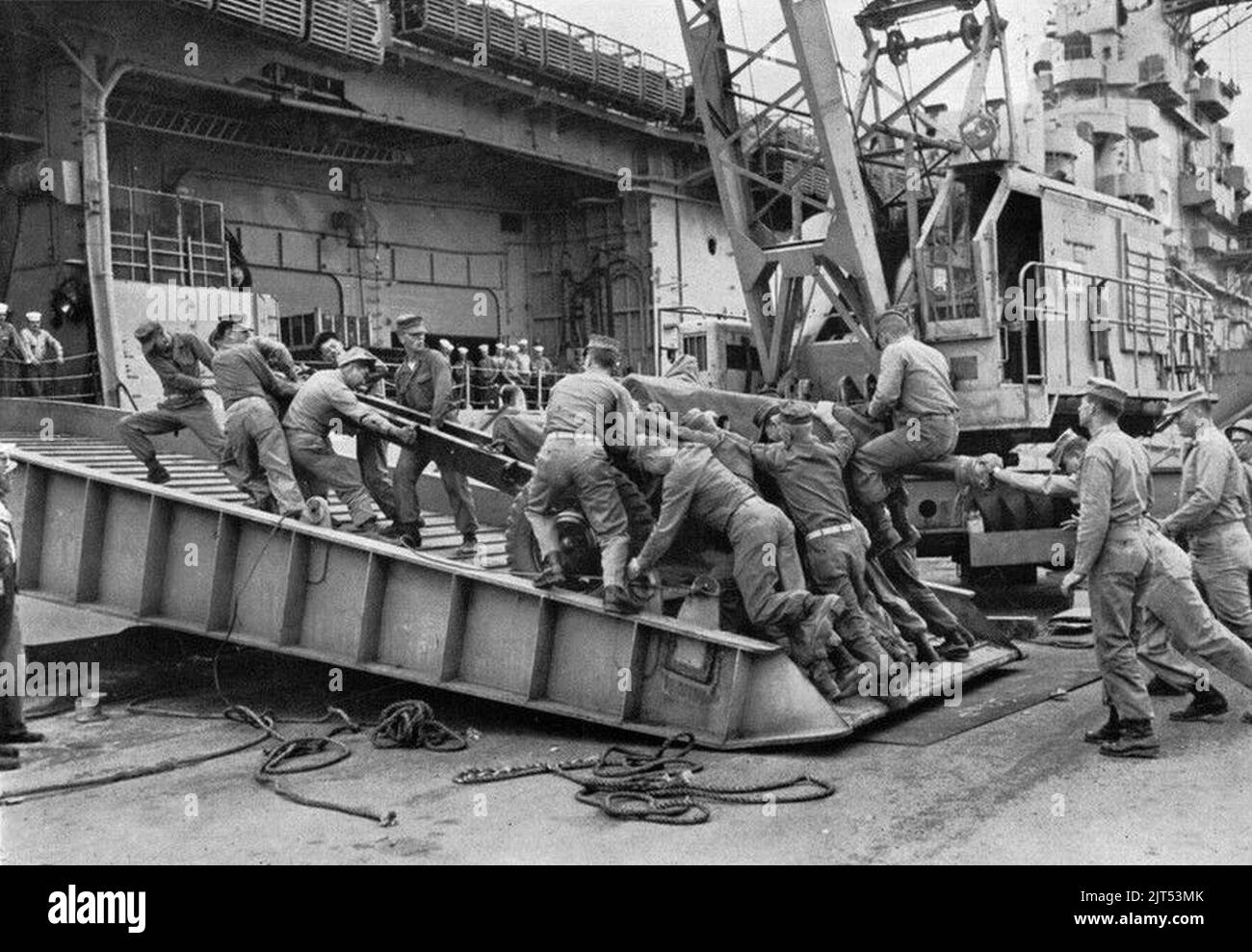 U.S. Marines load a M101 howitzer aboard USS Princeton (LPH-5), in 1960 ...