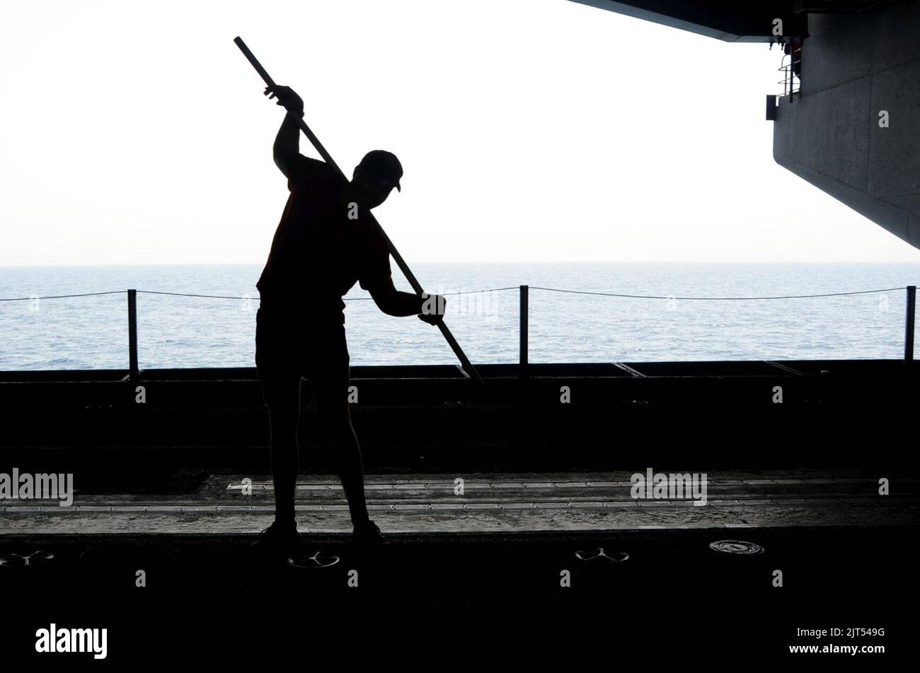 U.S. Naval Aircrewman (Tactical Helicopter) 2nd Class stretches before ...