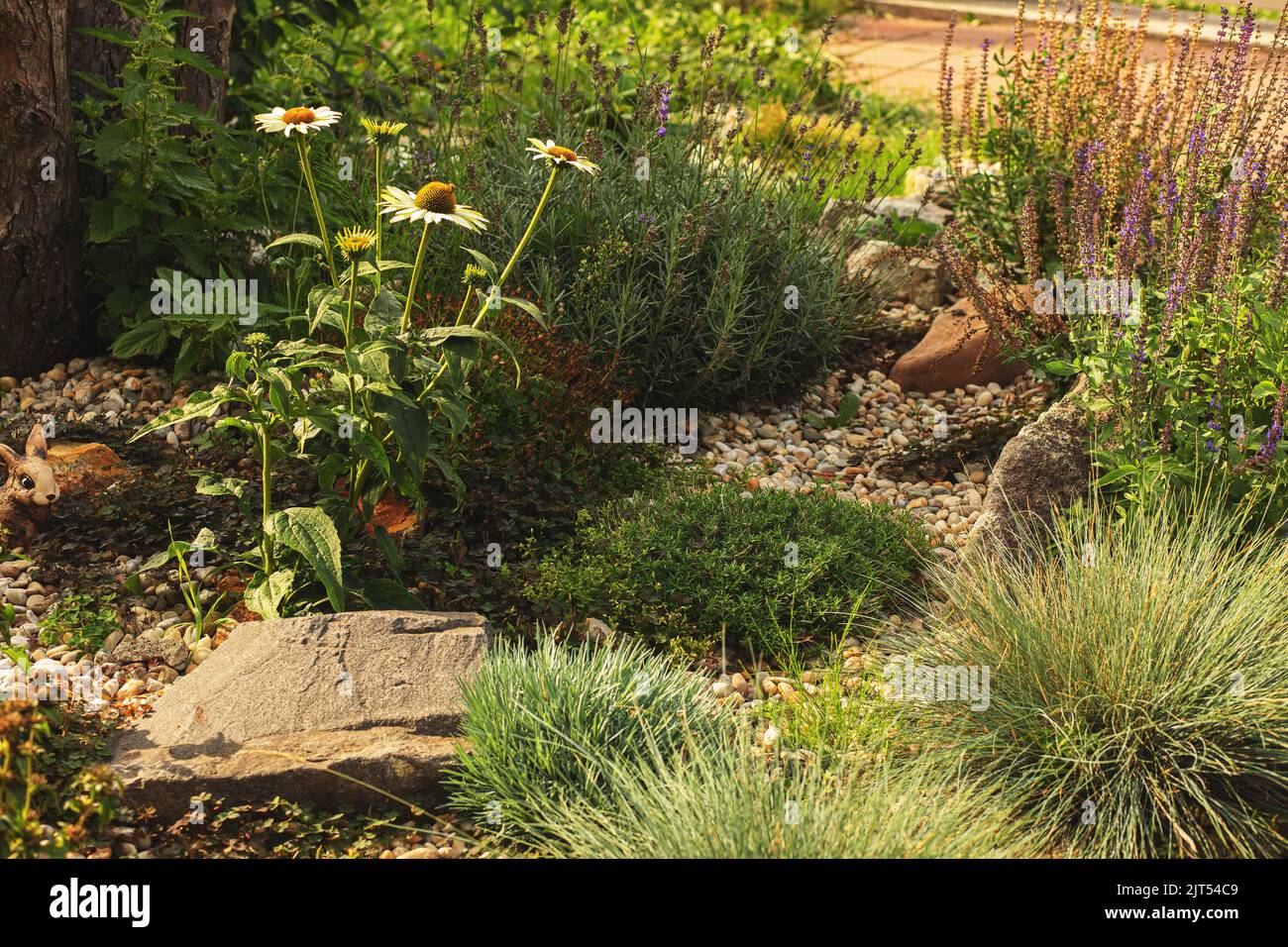 Decorated colorful flowerbed with stones as a decorative elements ...