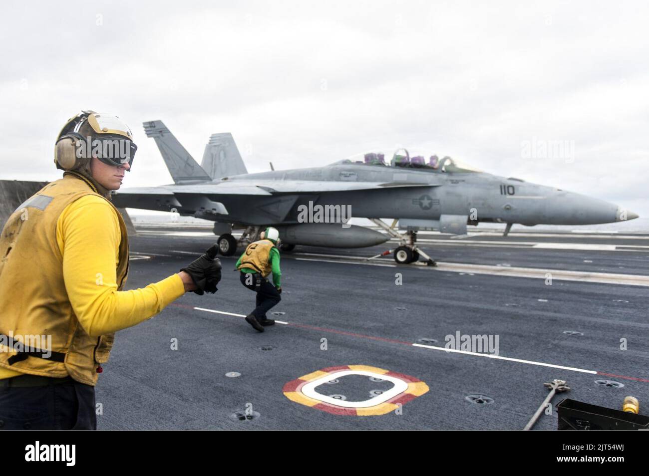 U.S. Navy Aviation Boatswain's Mate (Handling) 2nd Class foreground ...