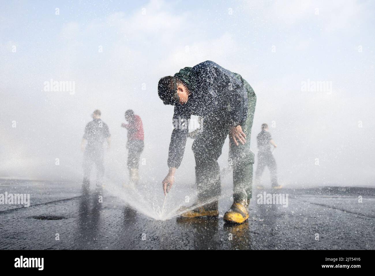 U.S. Navy Aviation Boatswain's Mate (Handling) Airman foreground ...