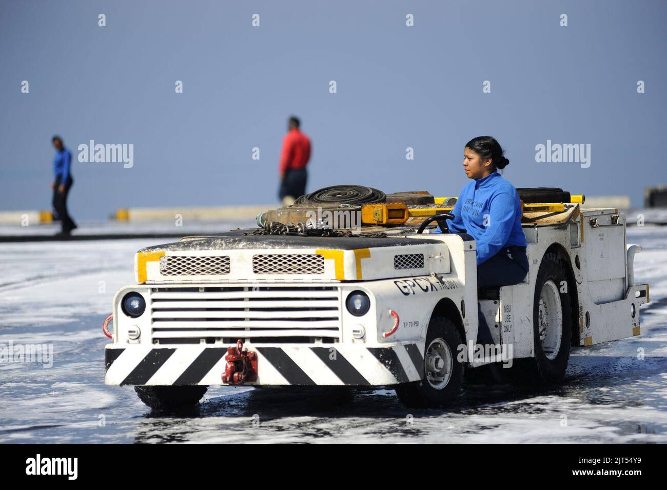 U.S. Navy Aviation Boatswain's Mate (Handling) 3rd Class drives an ...