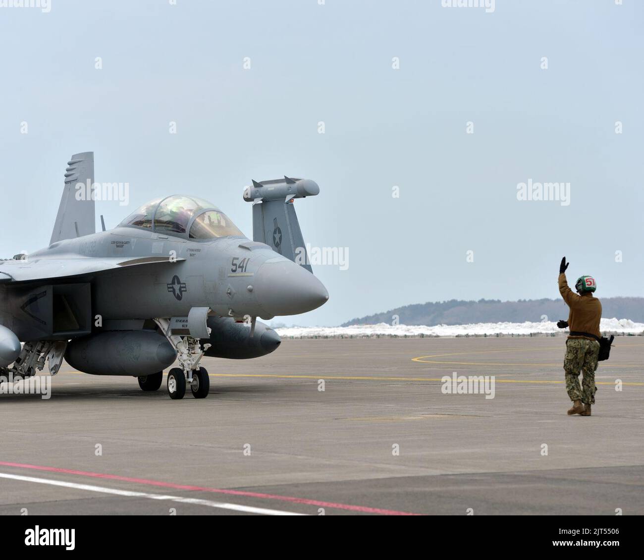 U.S. Navy Aviation Electronics Technician 2nd Class directs an EA-18G ...