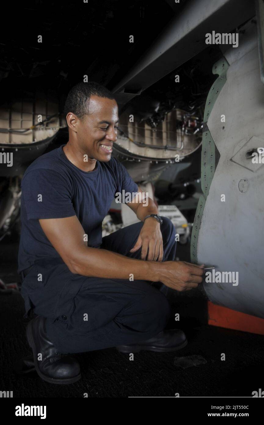 U.S. Navy Aviation Machinist's Mate 2nd Class performs corrosion ...