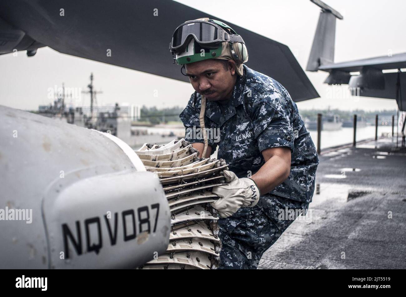 U.S. Navy Aviation Structural Mechanic 1st Class removes an aerial ...