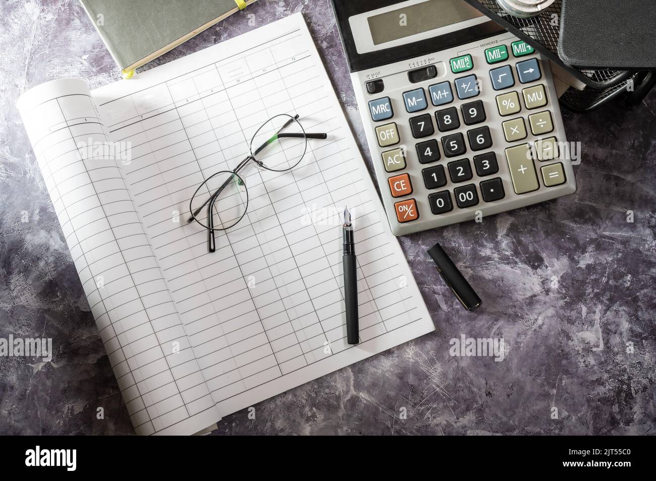 Journal for financial management. Magazine, glasses and calculator on ...