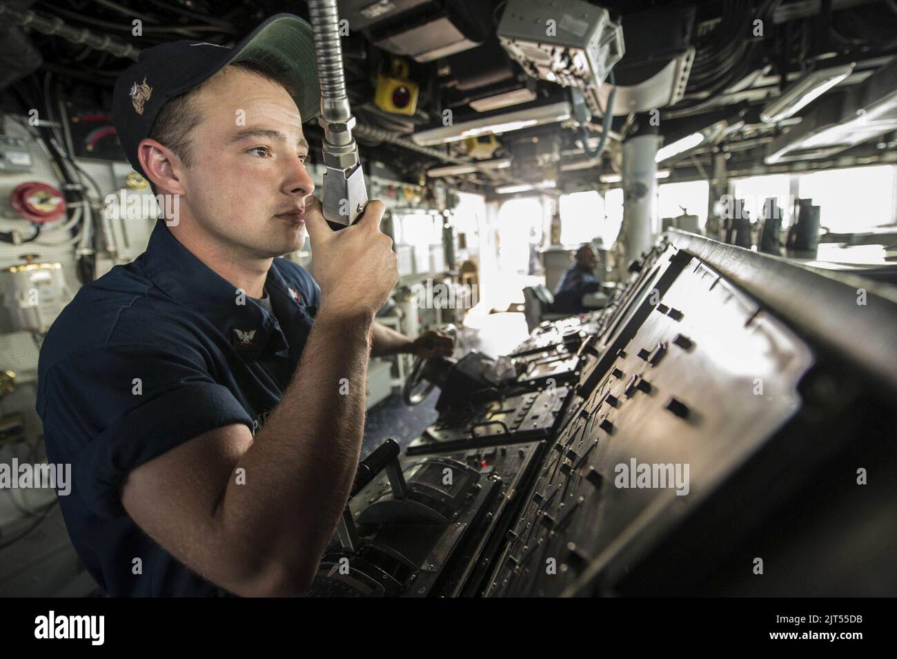 U.S. Navy Boatswain's Mate 3rd Class relays information to the conning ...