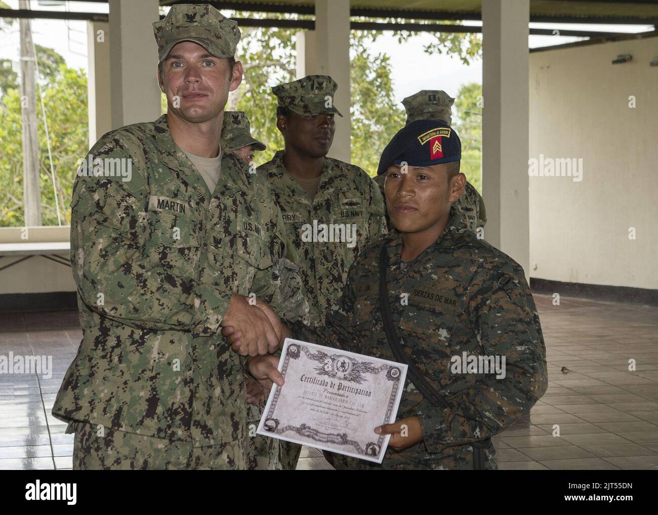 U.S. Navy Boatswain's Mate 3rd Class , left, attached to Coastal ...