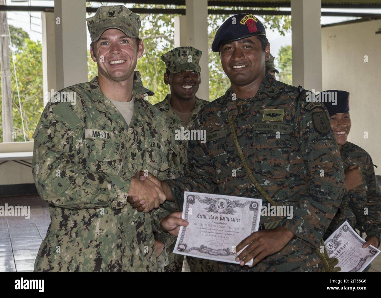 U.S. Navy Boatswain's Mate 3rd Class , left, attached to Coastal ...