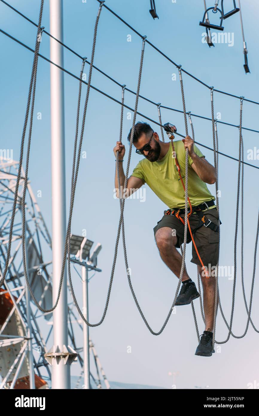 Man handling the hardest rope level with no difficulty in an adventure ...