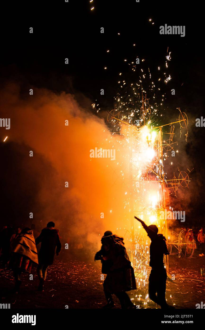 A vertical shot of people dancing around fireworks during the Corpus ...