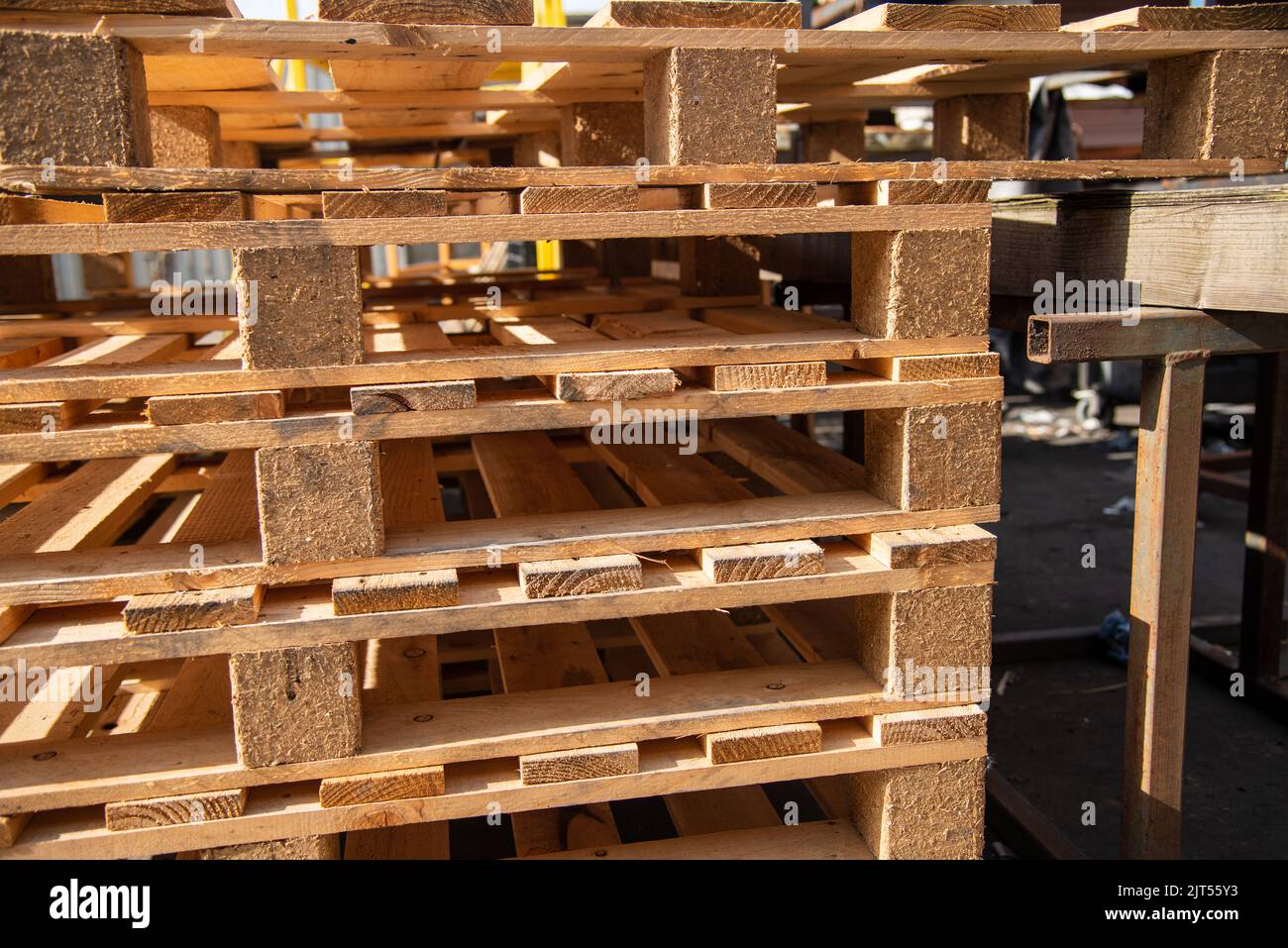 Stack of wooden pallets at storage warehouse. industrial logistics and ...