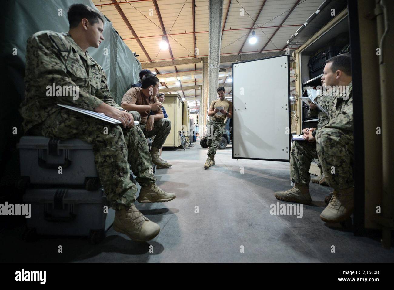 U.S. Navy Chief Hull Maintenance Technician Mario Pais, center ...