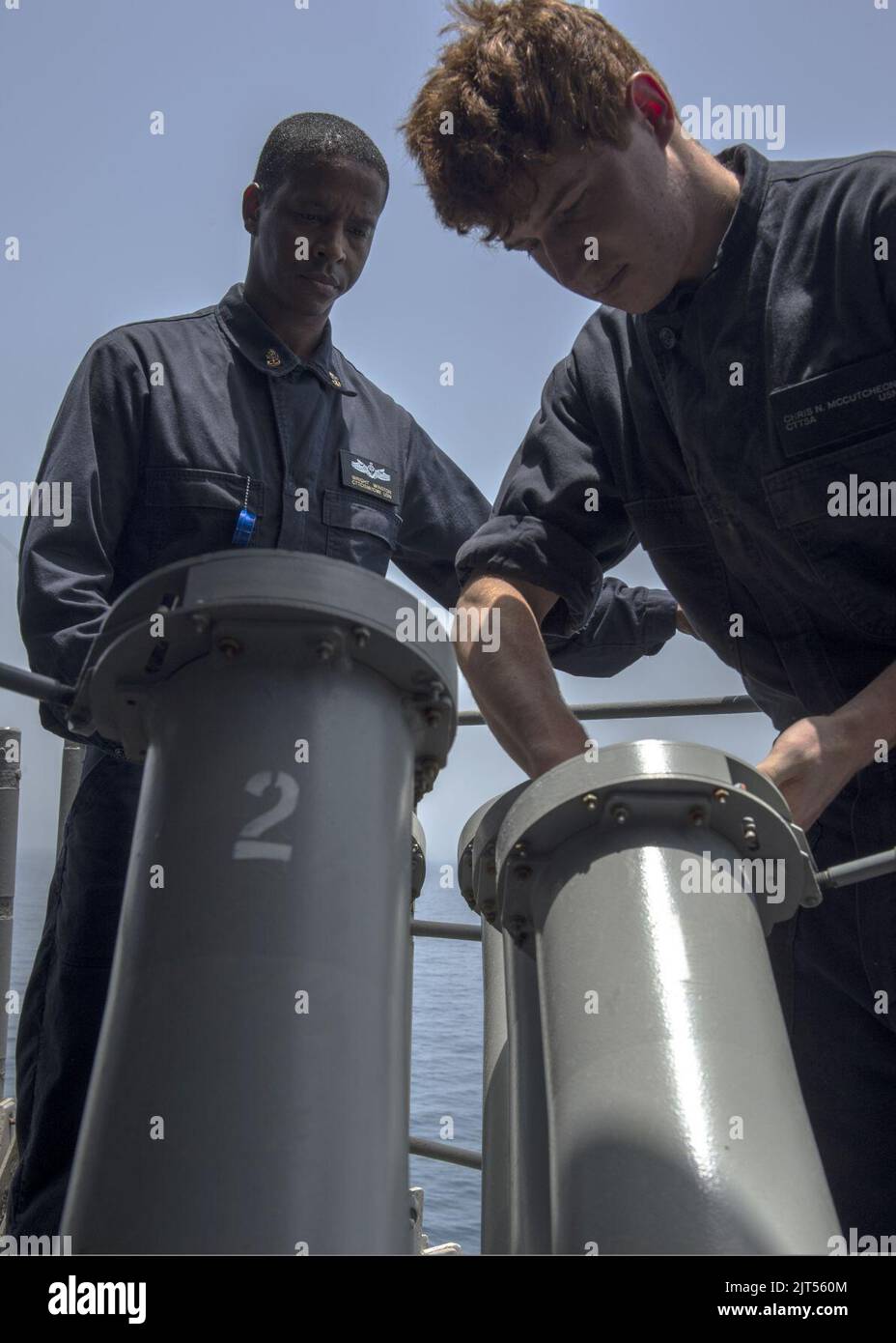 U.S. Navy Chief Cryptologic Technician (Technical) left, supervises as ...