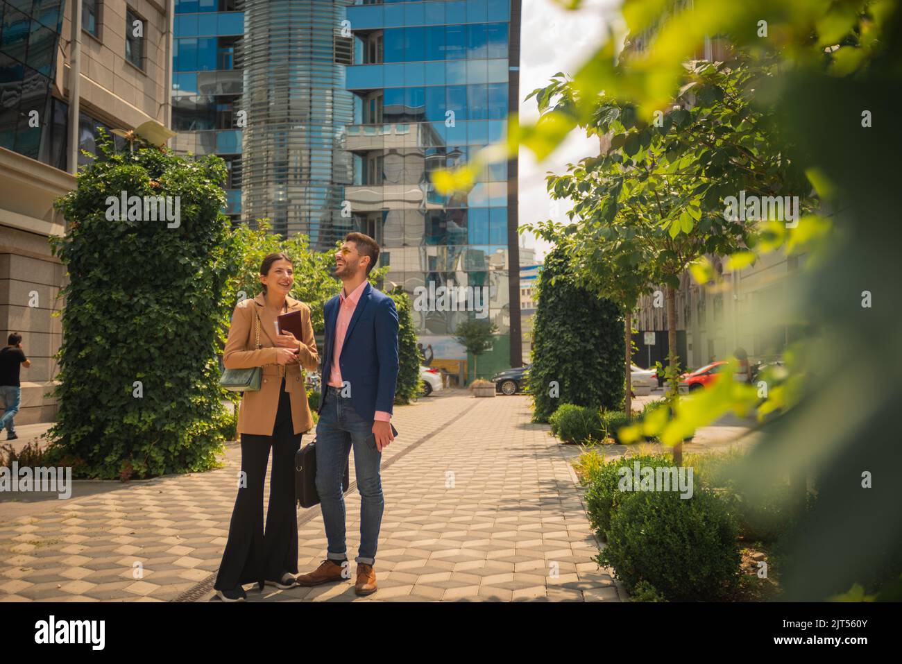 Two beautiful business colleagues are laughing and having fun in the ...