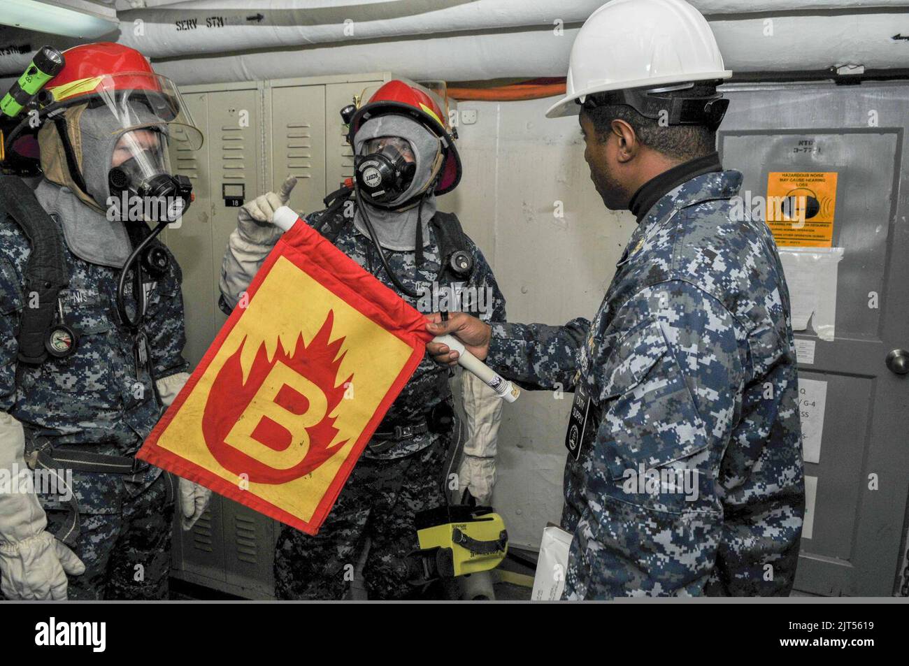 U.S. Navy Chief Logistics Specialist Damon Hankins, right, a damage ...
