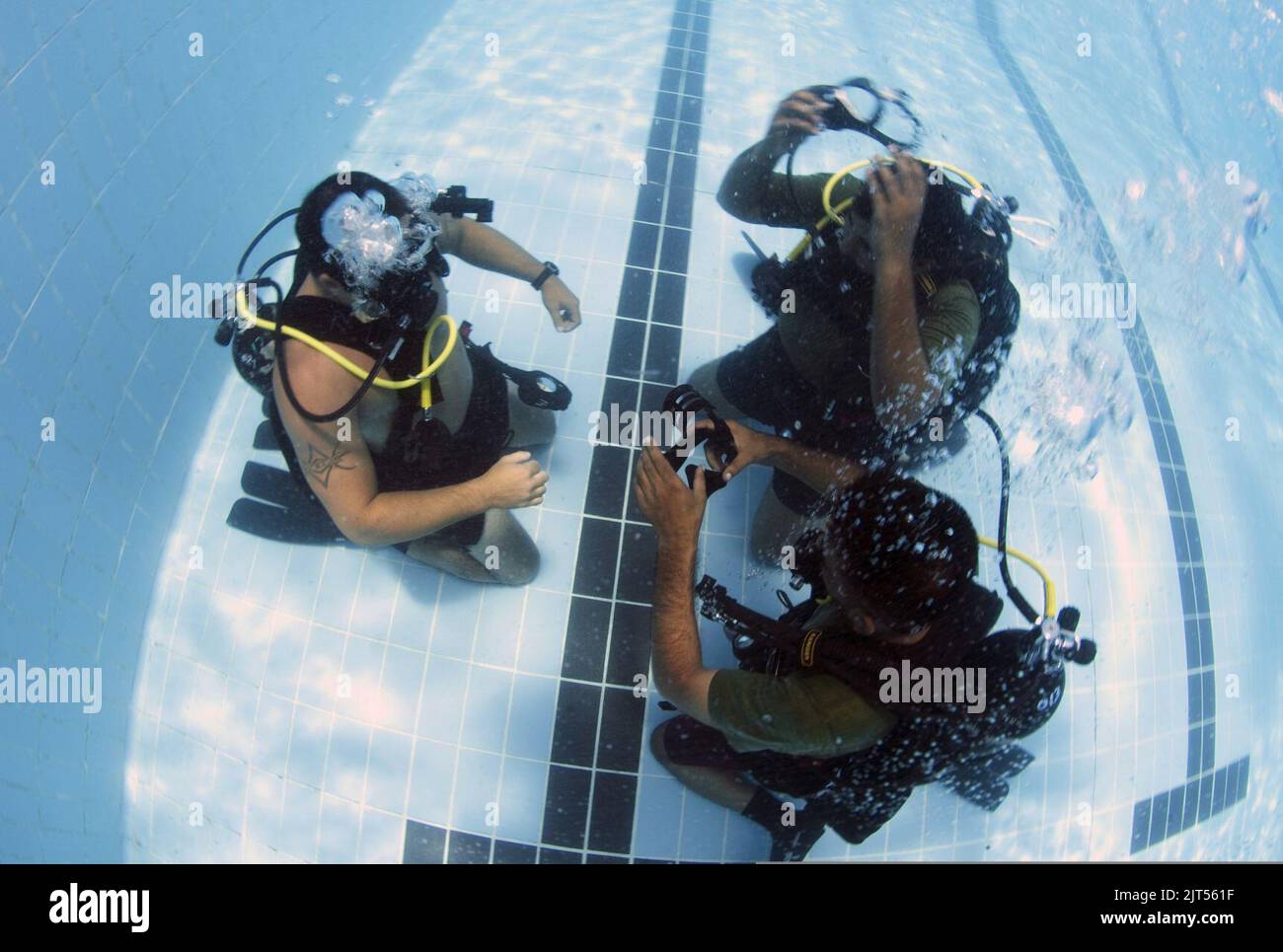 U.S. Navy Chief Navy Diver left, assigned to Commander, Task Group (CTG ...