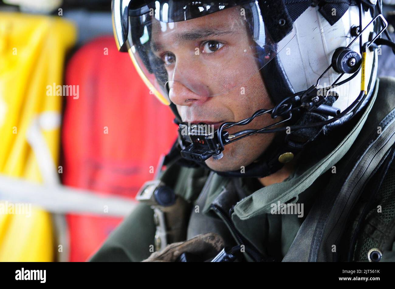 U.S. Navy Chief Naval Air Crewman speaks through an internal ...