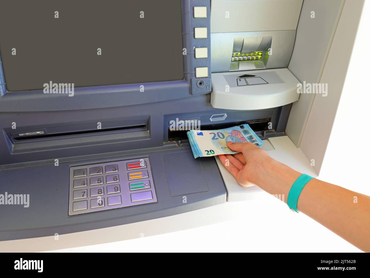 hand taking European banknotes from an ATM cash machine and the numeric ...