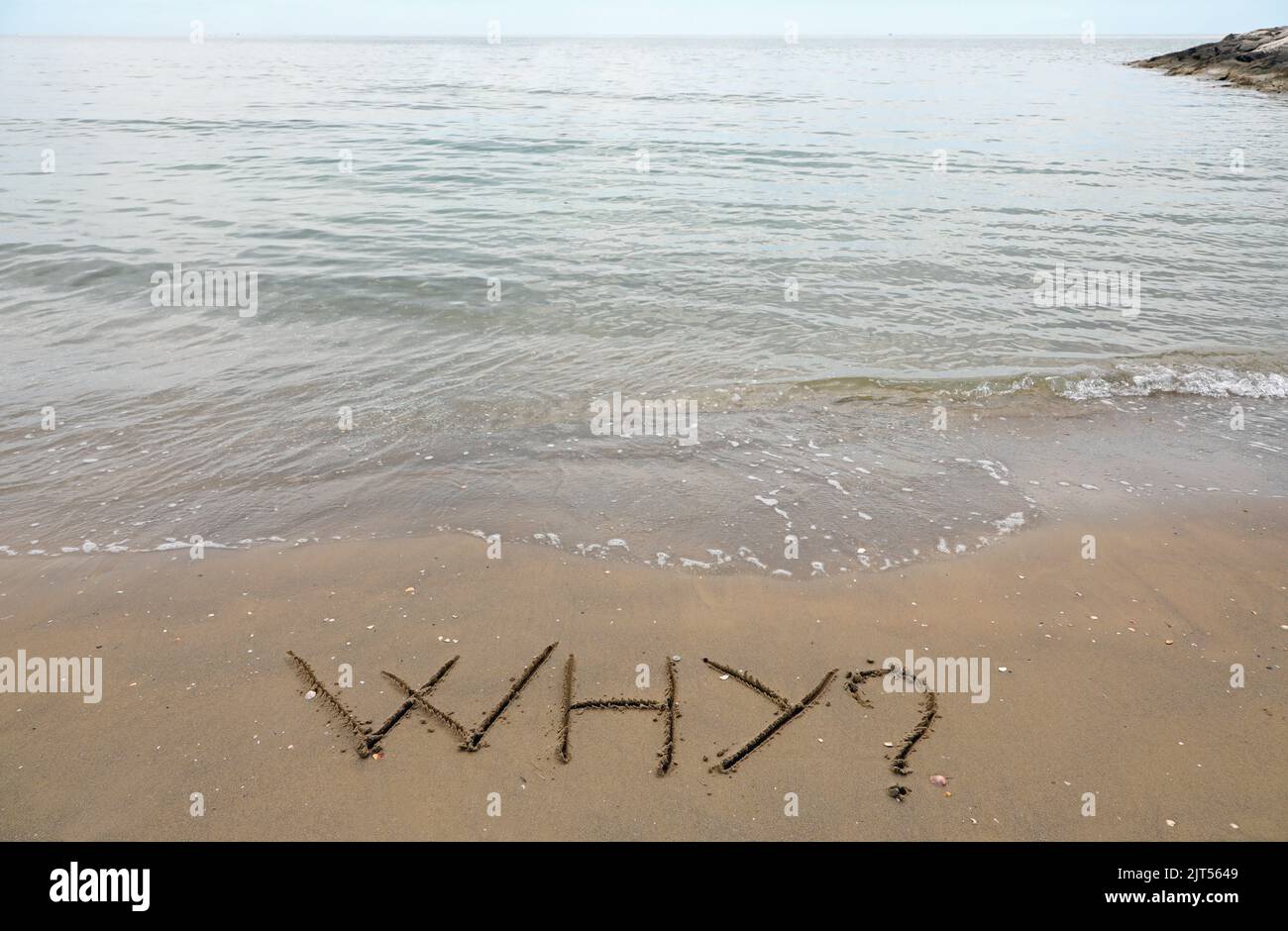 great text why with question mark written in the sand by the sea Stock ...