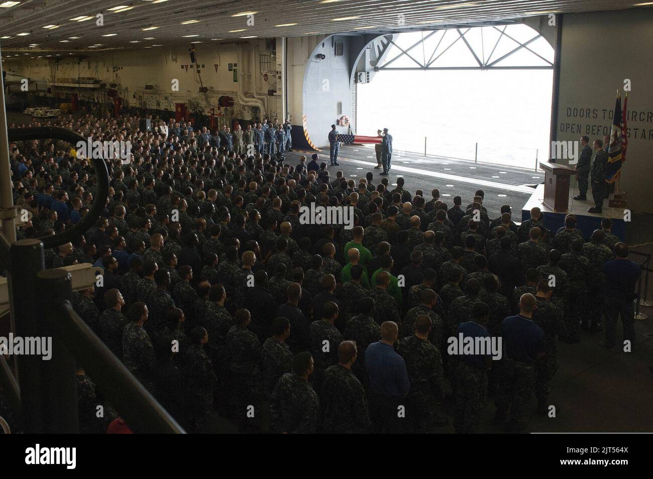 U.S. Navy chief petty officer selectees fold a U.S. flag as part of a 9 ...