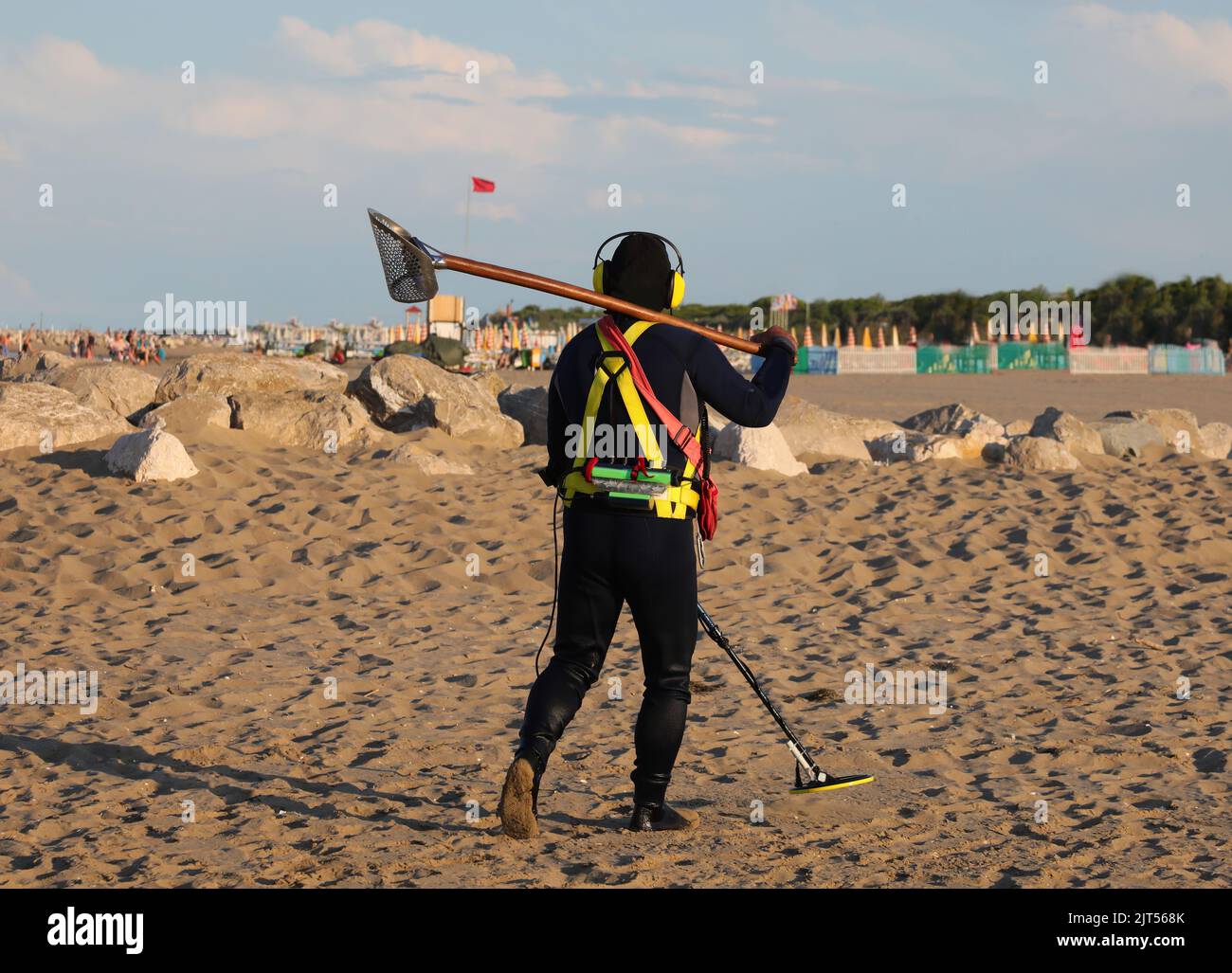 person with diving suit and metal detector looking for lost metal ...