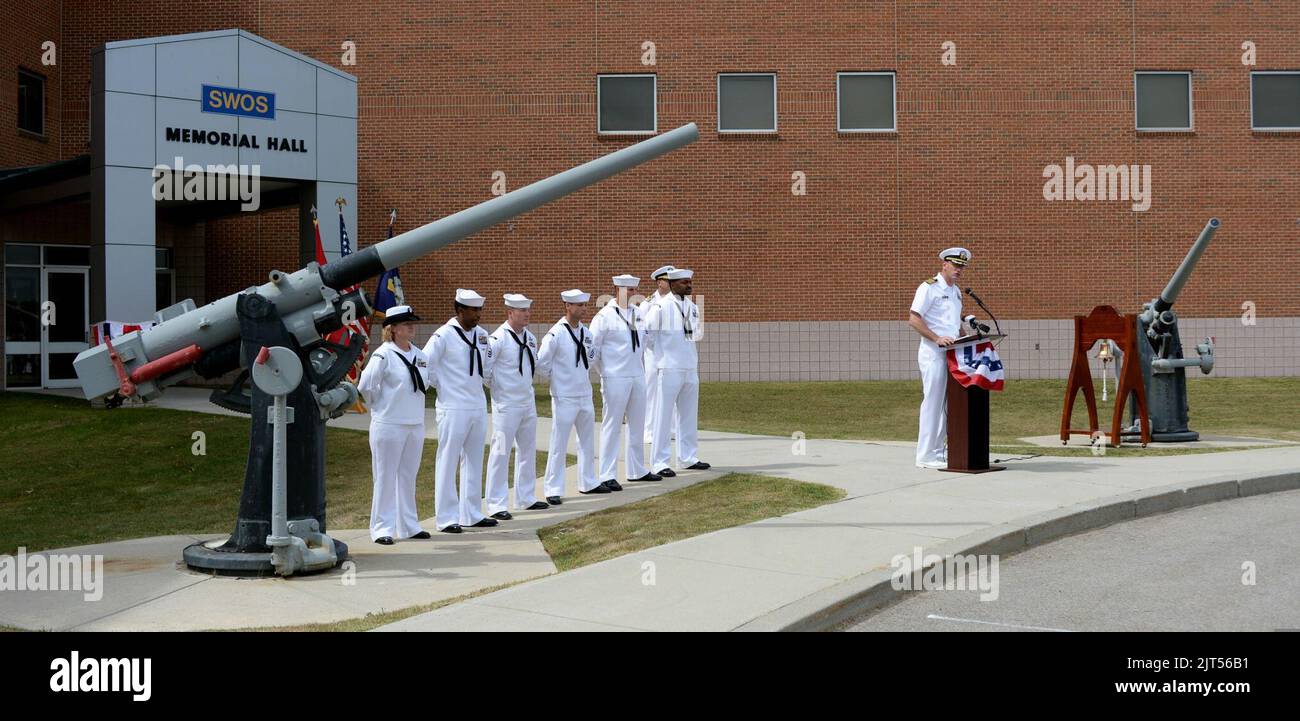 U.S. Navy chief selectees stand in formation as Capt. , at lectern, the ...