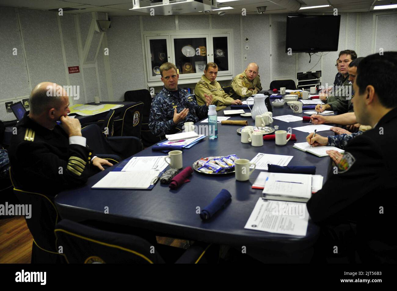 U.S. Navy Cmdr. Andrew Biehn, second from left, the commanding officer ...