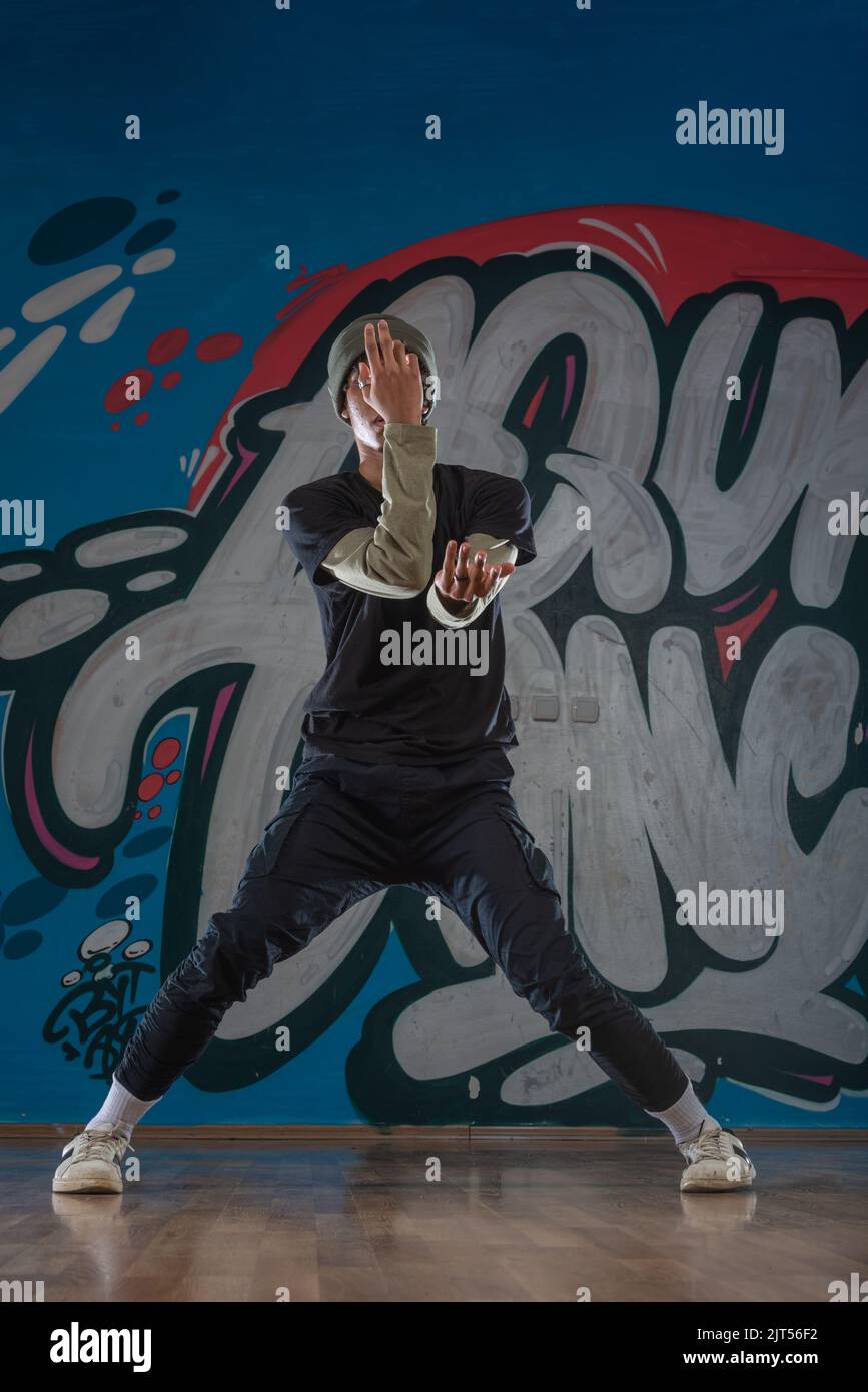 Modern rapper dancing in garage. Urban lifestyle, hip hop Stock Photo ...