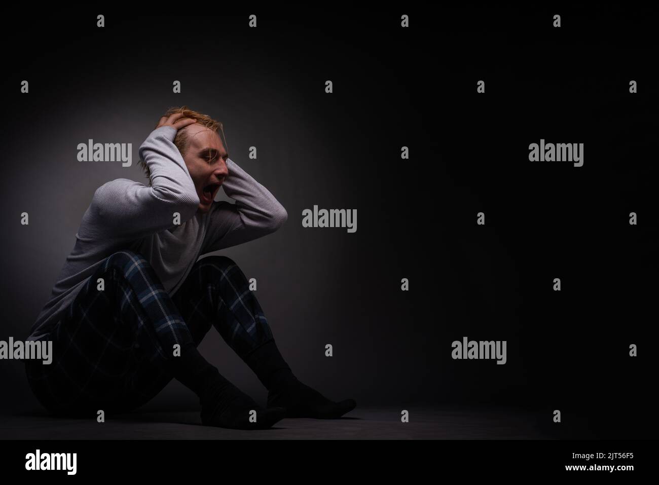 Sad boy is screaming out loud to get the pain out of him Stock Photo ...