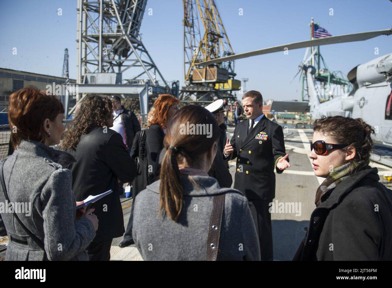 U.S. Navy Cmdr. Andrew Biehn, second from right, the commanding officer ...
